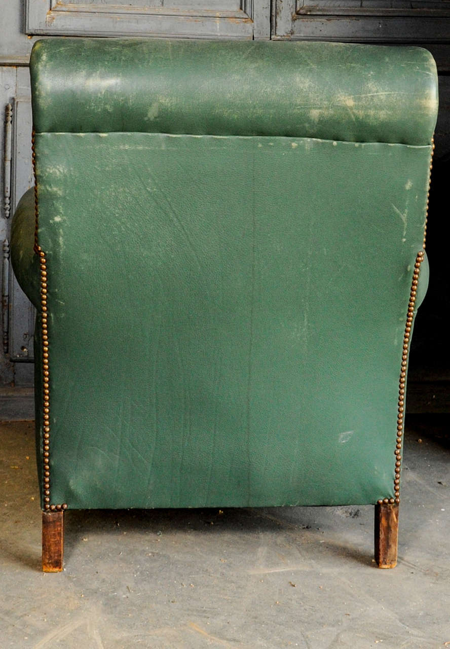A pair of antique green leather club seats at 1stDibs