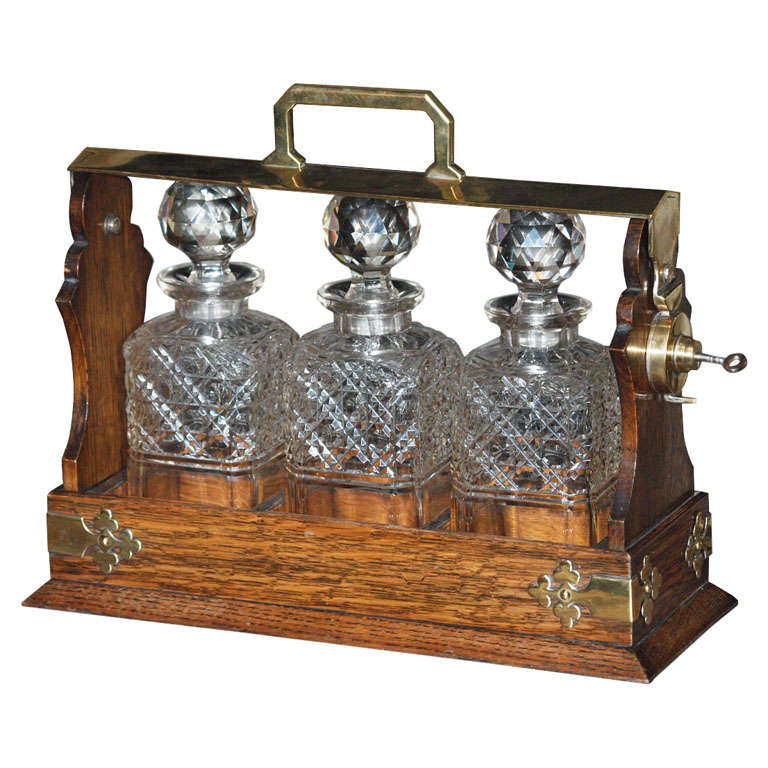 (L-5550) Antique English oak and brass three-bottle tantalus set. at ...