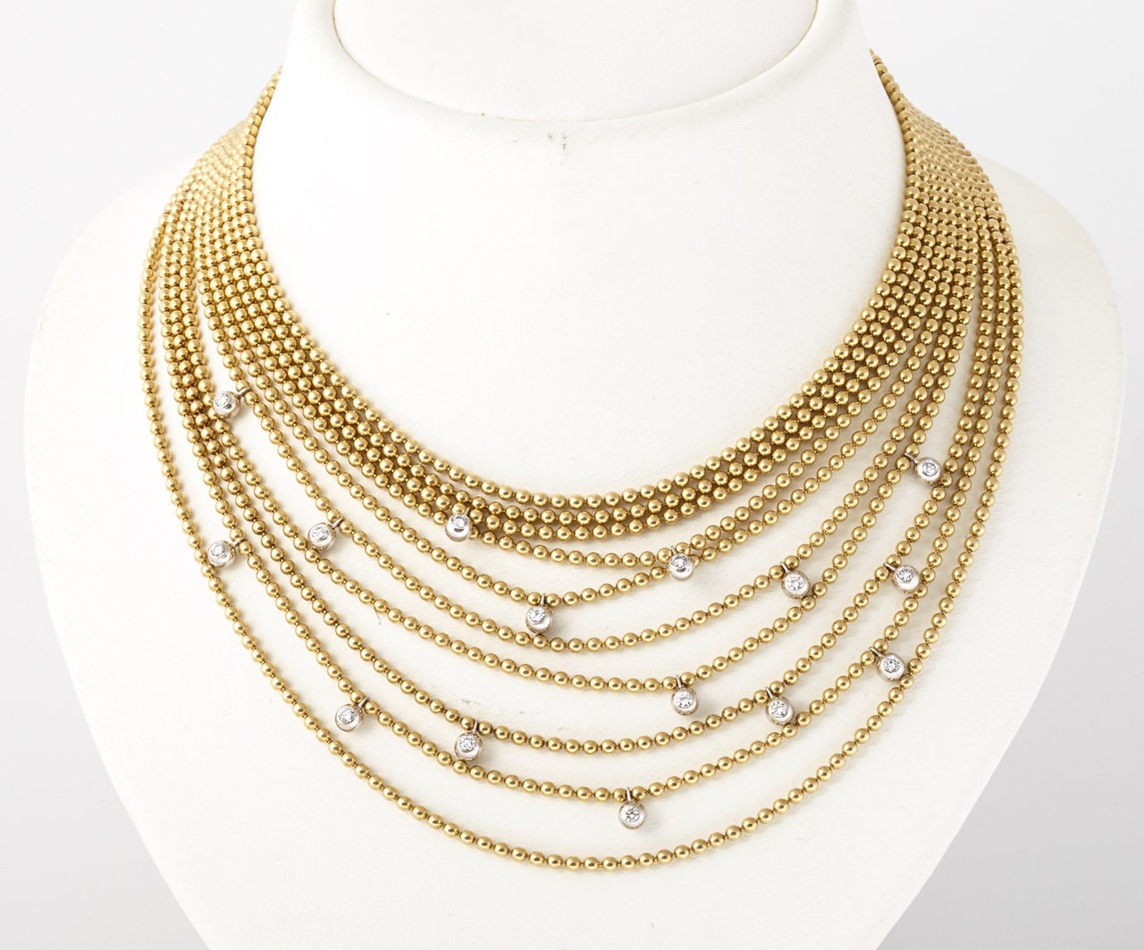 A gold and diamond draperie ball necklace by Cartier at 1stDibs