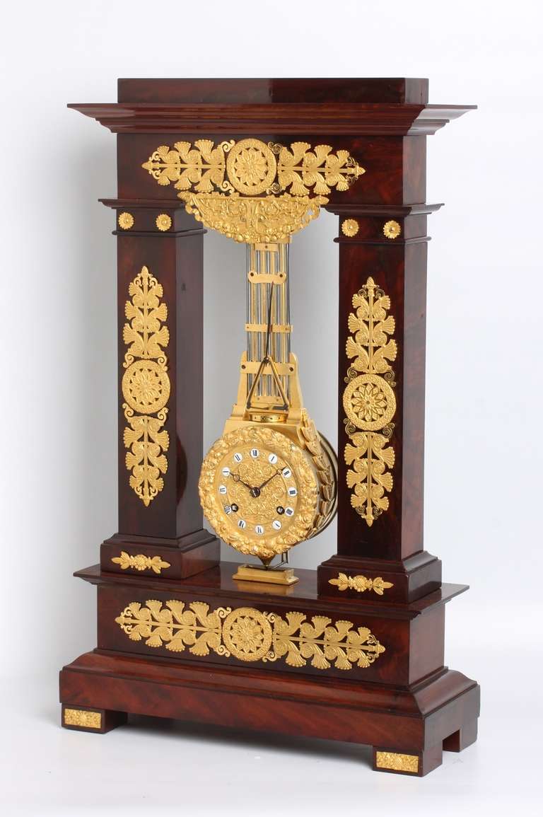 A French late-Empire mahogany and ormolu oscillating mantel clock ...