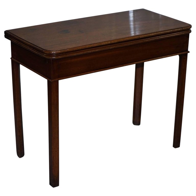 An Edwardian period ‘Centennial’ mahogany swivel and fold-over top card ...