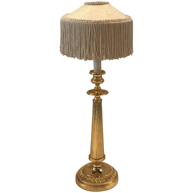 French Gilt Candlestick Lamp with Fringed Shade For Sale at 1stDibs