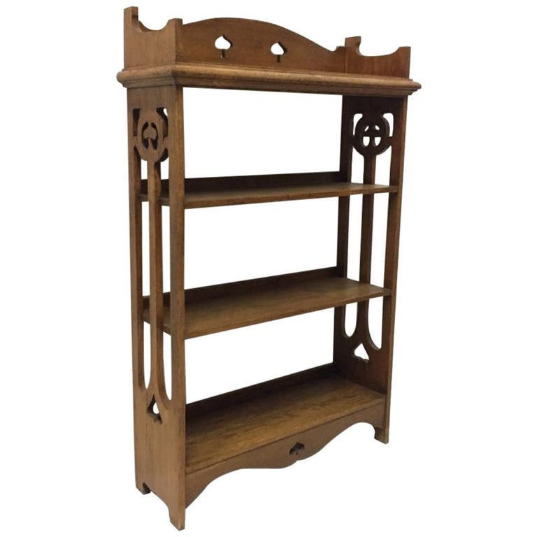 Liberty and Co Attributed, an Arts and Crafts Oak Bookcase with floral ...
