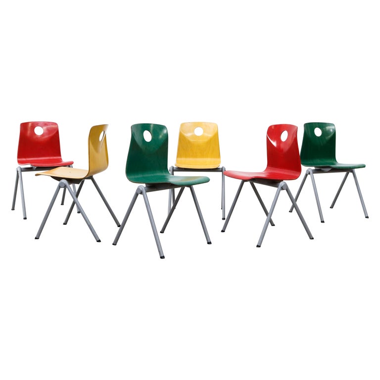 Multi-Colored Stacking Chairs with Circle Cut out at 1stDibs