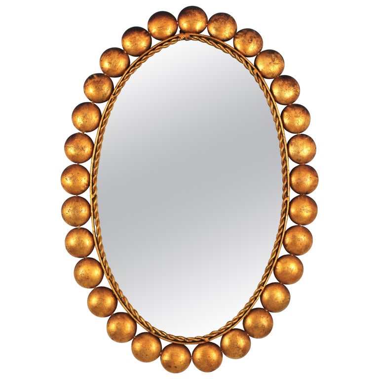 Gilt Metal Oval Mirror with Balls Frame For Sale at 1stDibs