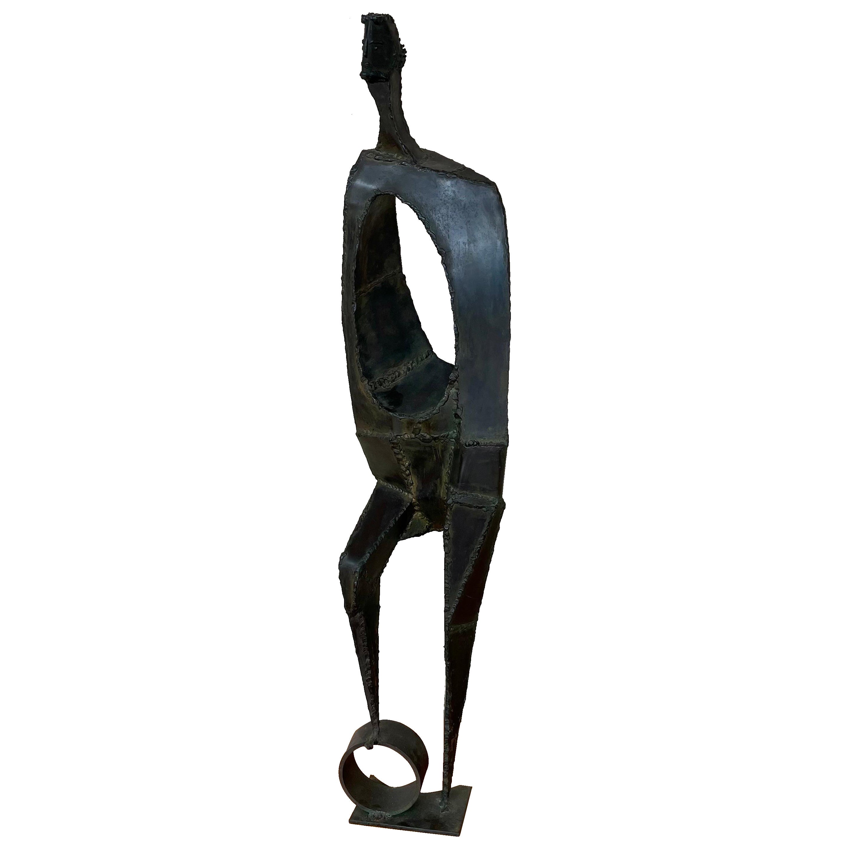 Tall and nice metal sculpture with led stand of men figures. at 1stDibs