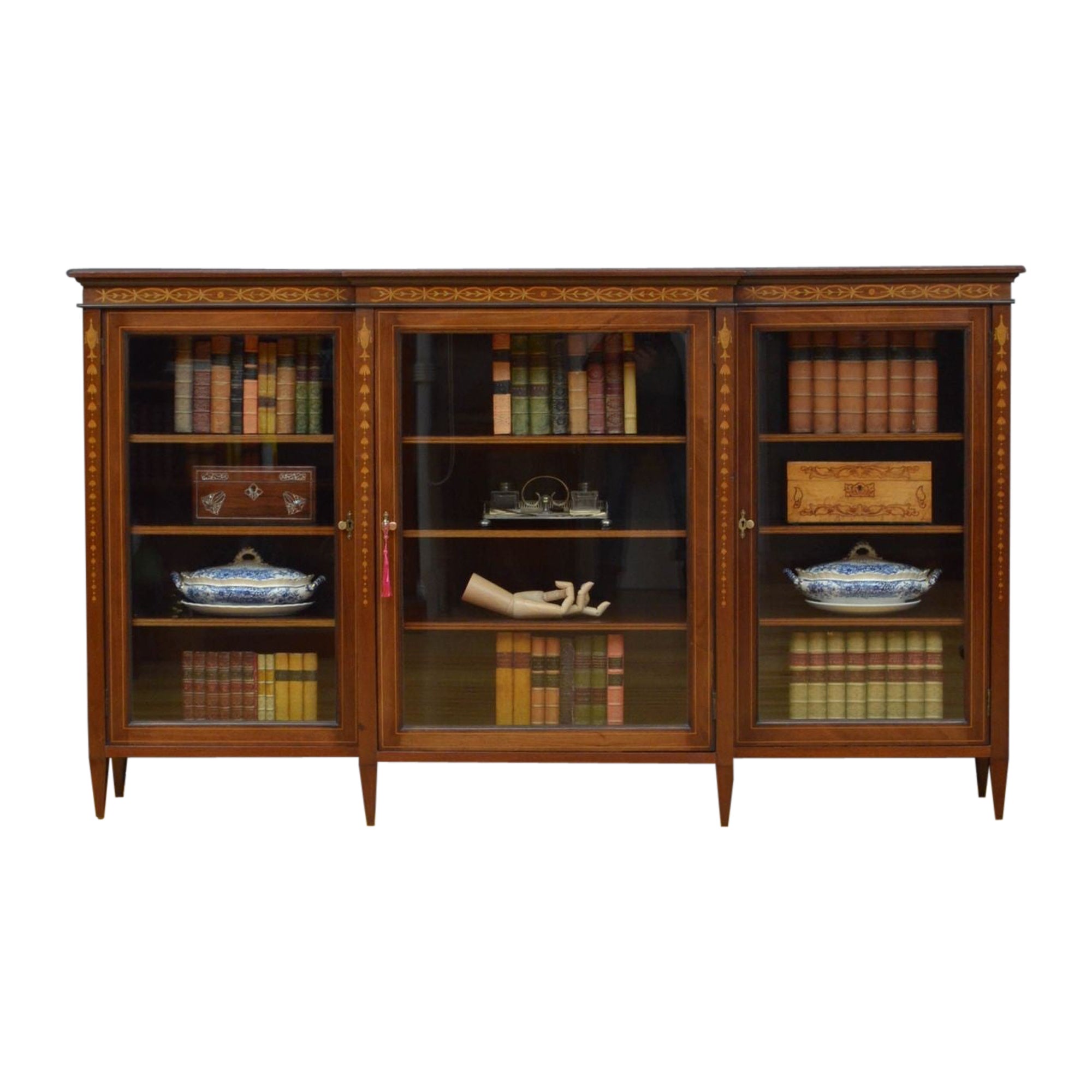 A cream painted wooden neoclassical bookcase in two sections at 1stDibs