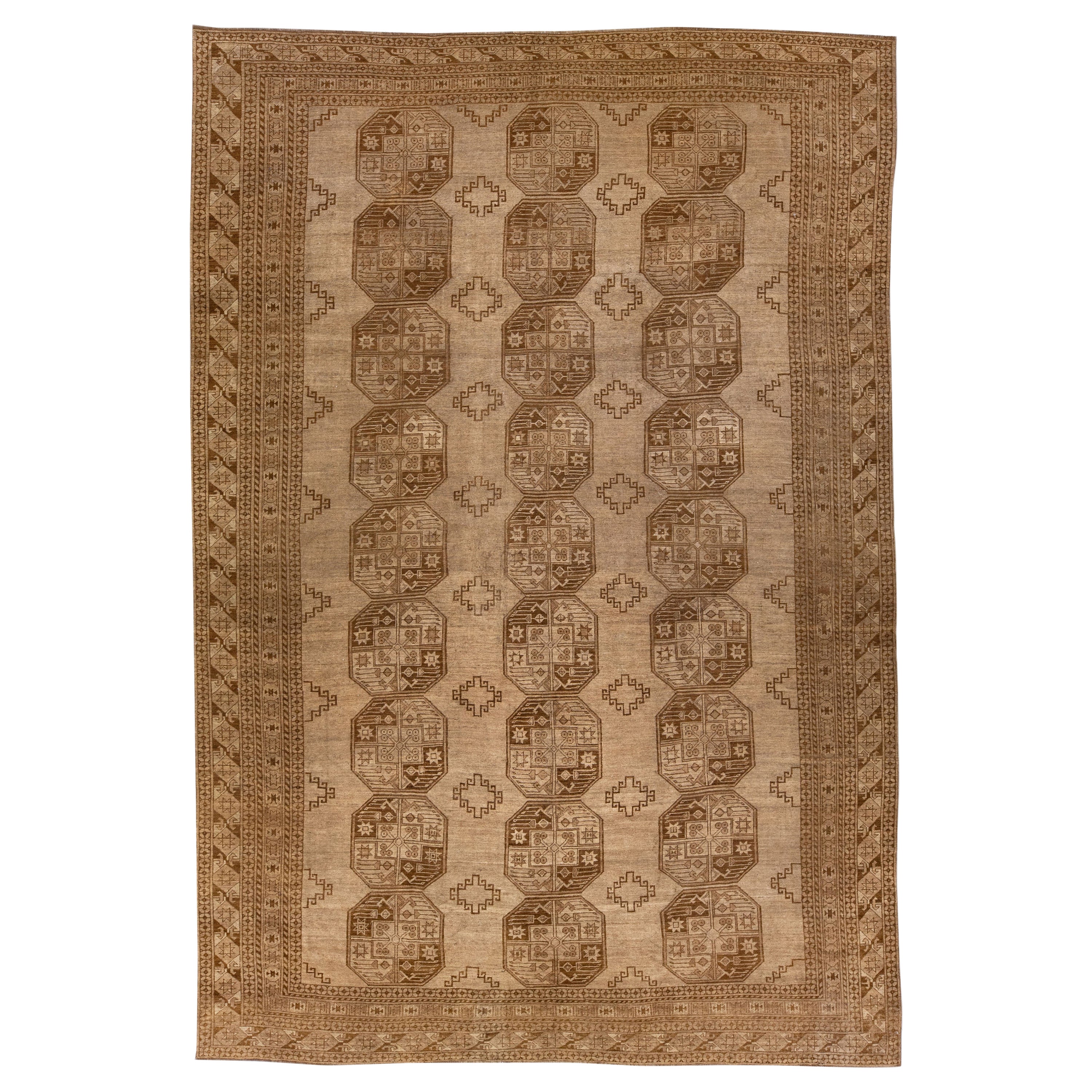 Antique Turkmen Handmade Brown Wool Rug with Gul Design For Sale at 1stDibs