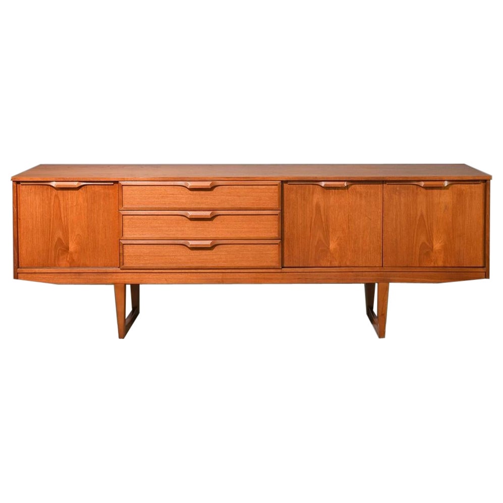 A large 80” mid century modern teak sideboard featuring sleigh legs For ...