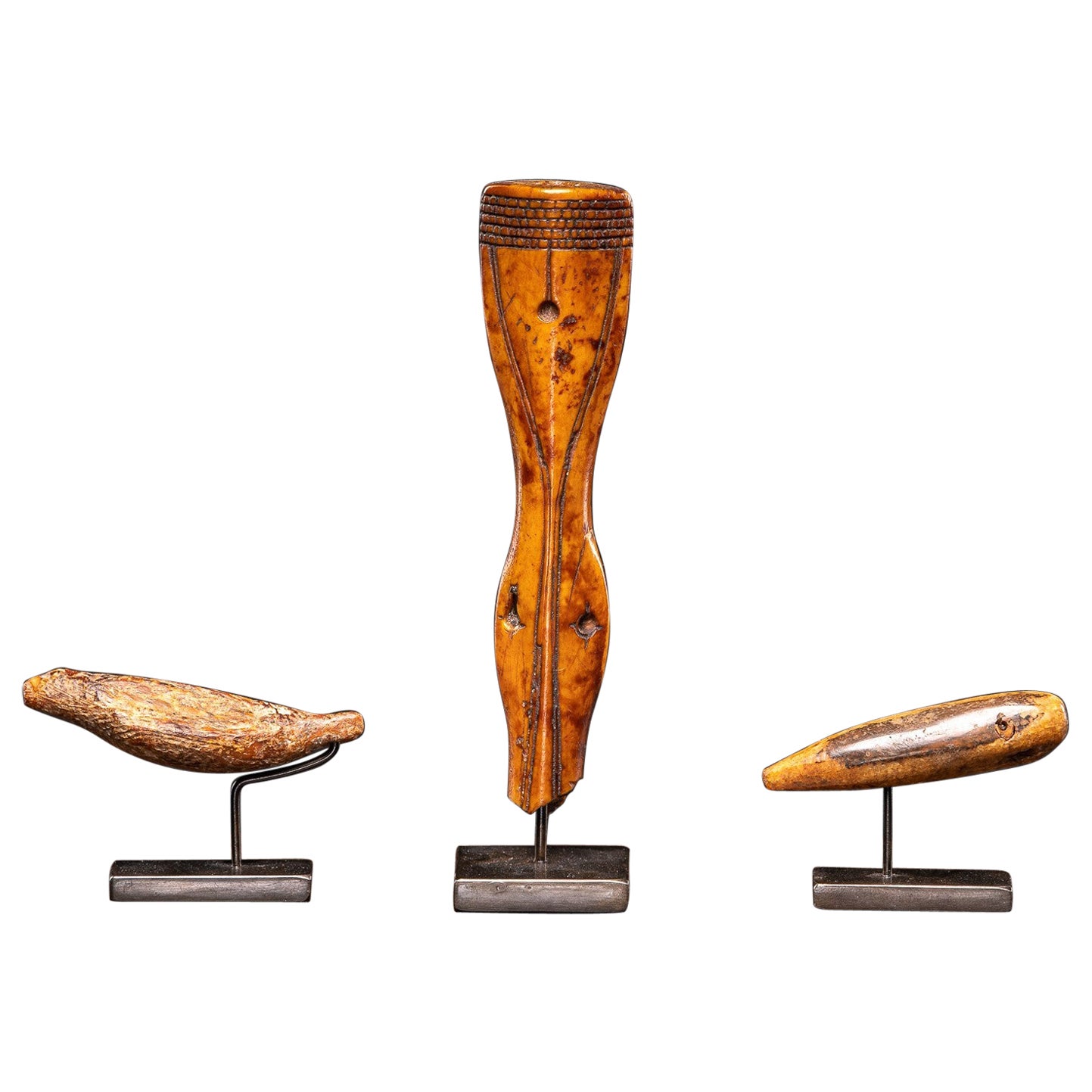 Two Inuit Marine Ivory Toggles carved as a Seal and a decorated Needle ...