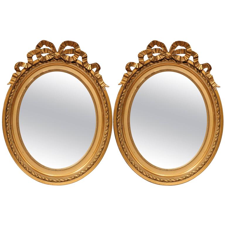 Pair of 19th Century French Louis XVI Oval Gilt Mirrors with Carved ...