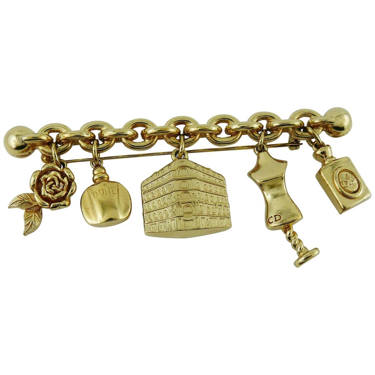 Christian Dior Gold Toned Brooch with Charms at 1stDibs