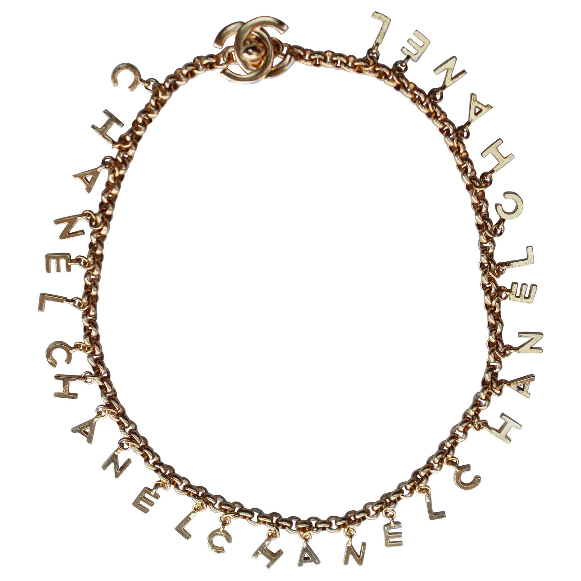 CHANEL 1996P Gilted metal chain with "Chanel" letters charms at 1stDibs