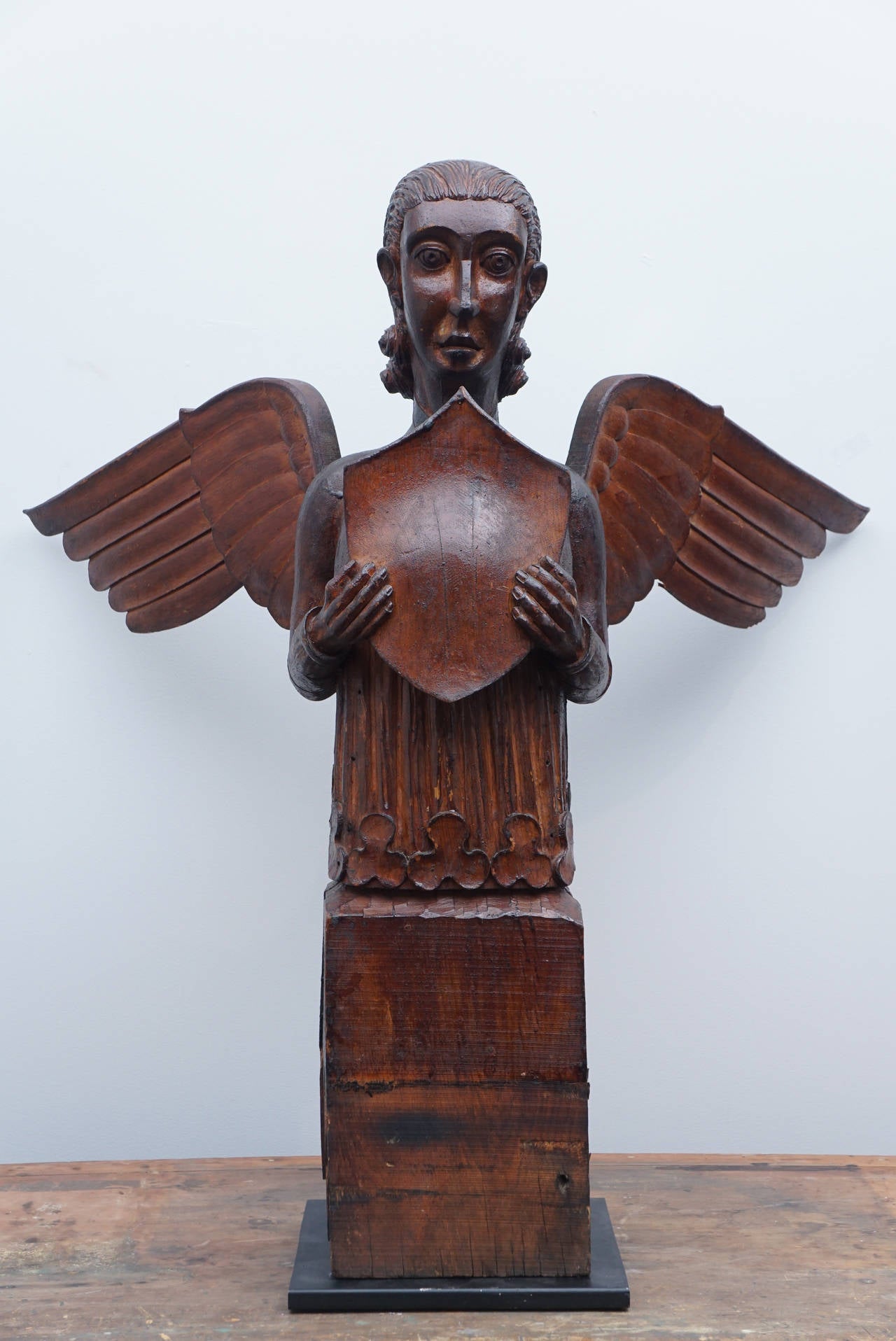 Large Carved Beatific Figure with Shield and Wings at 1stDibs