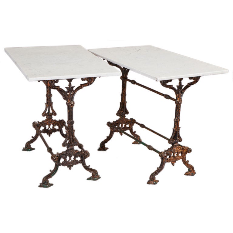 Two, French, cast iron tables, marble tops. at 1stDibs