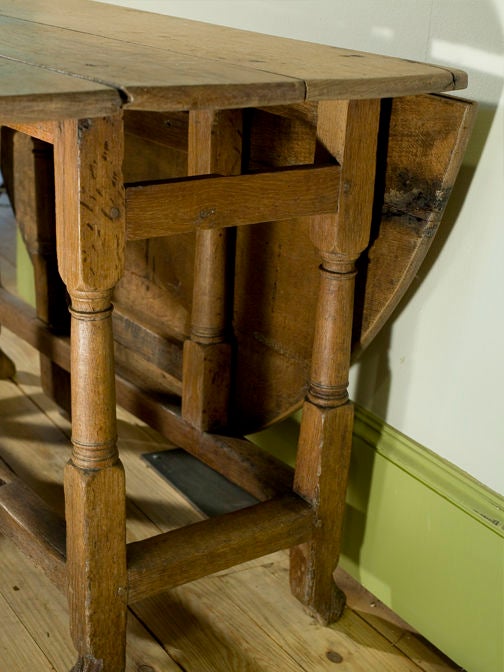 Antique oak drop-leaf table with animal paw foot at 1stDibs