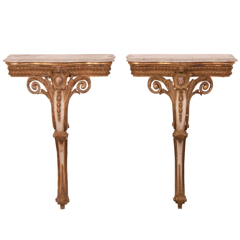 A pair of gilded and painted single leg console tables from Italy c ...