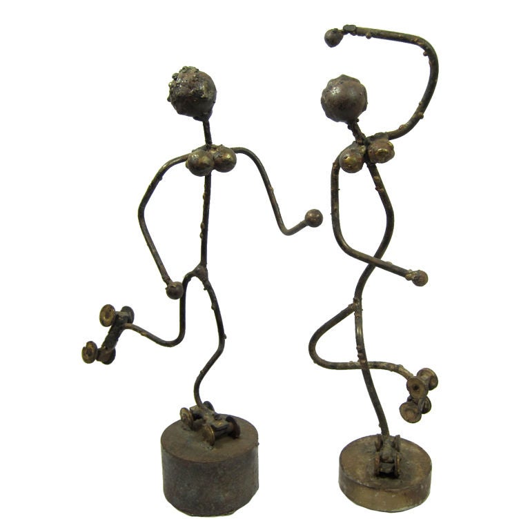 Pair of Mid Century Roller Skating Iron Figure Sculptures at 1stDibs