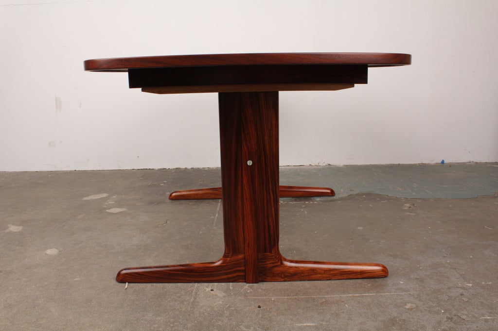Danish mid century modern rosewood pedestal oval dining table. at 1stDibs