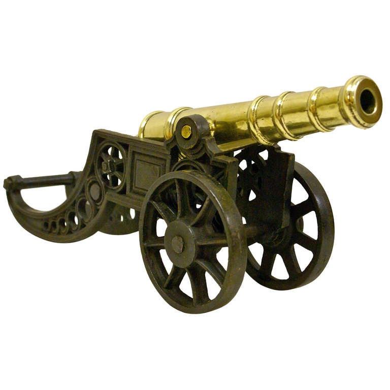 A Victorian brass ornamental cannon on cast iron carriage. at 1stDibs