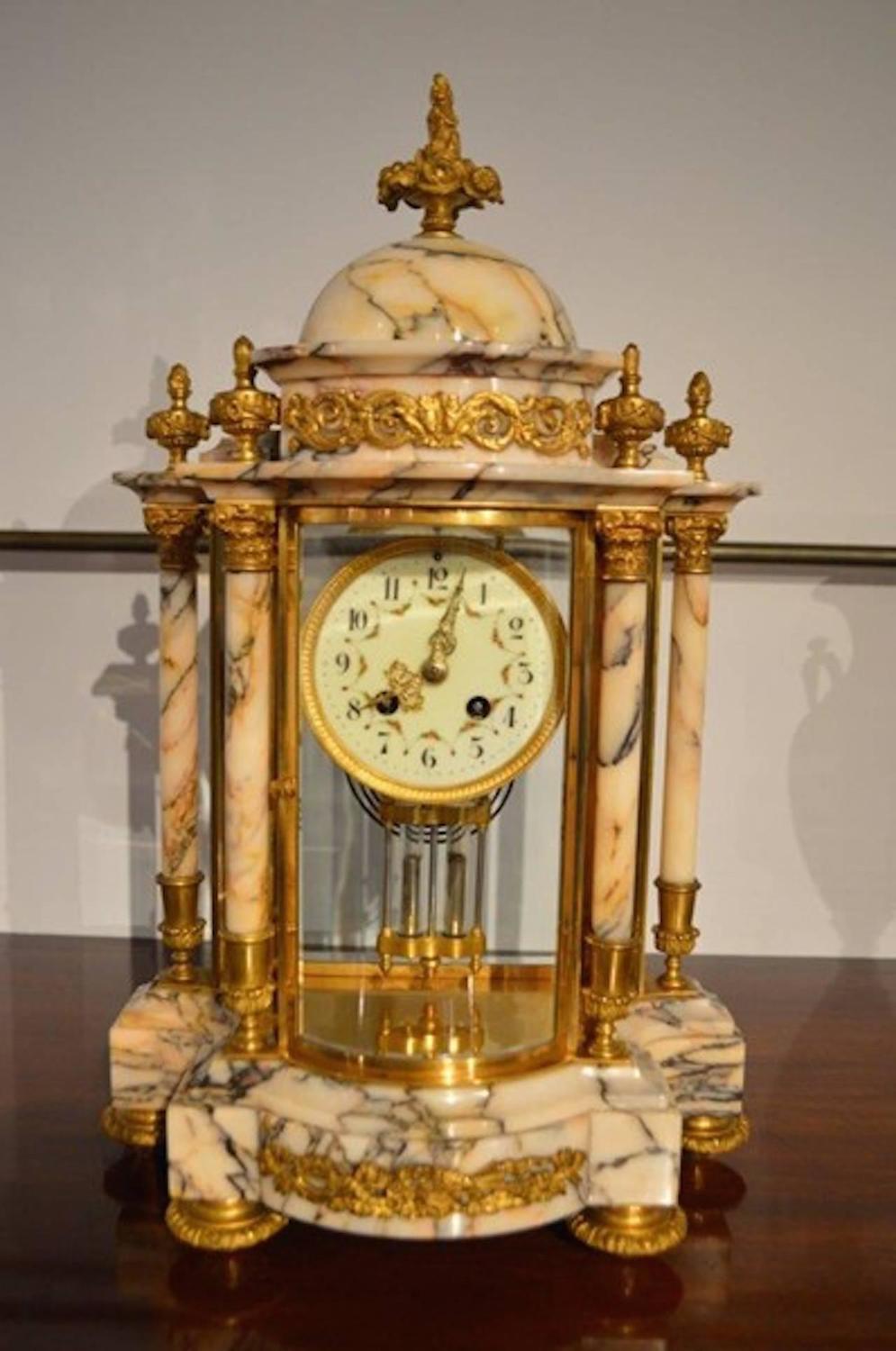 A beautiful French marble and ormolu clock garniture. at 1stdibs