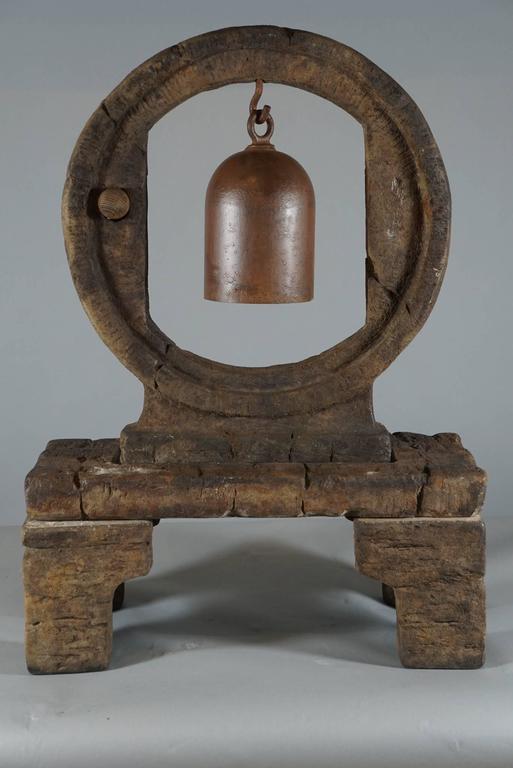 Resonant Iron Bell Suspended in Large Cast Stone Wheel on Stand at ...