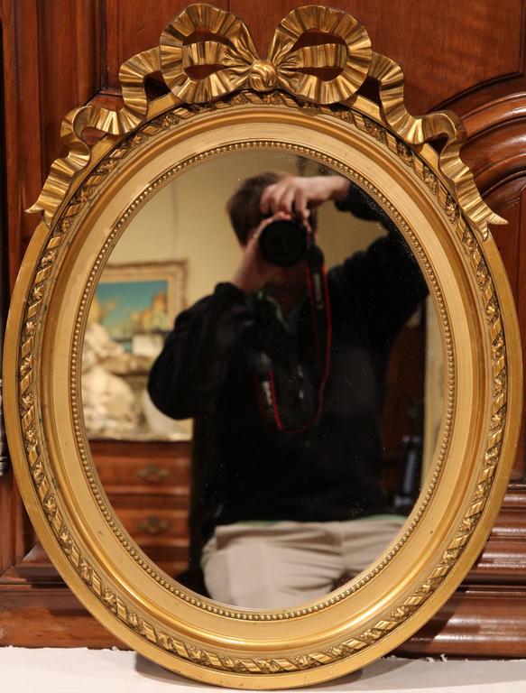 Pair of 19th Century French Louis XVI Oval Gilt Mirrors with Carved ...