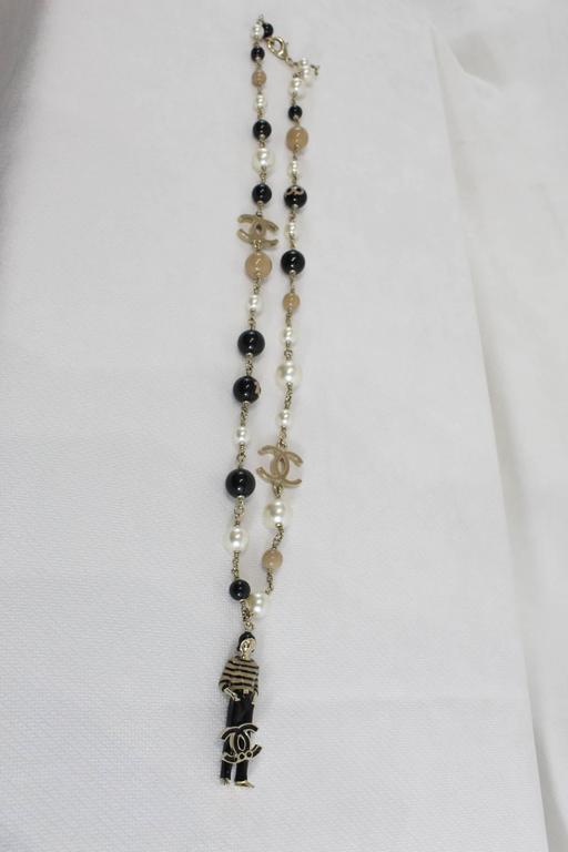 Chanel Fake Pearls and Charms Necklace with Chanel Doll Pendant at ...