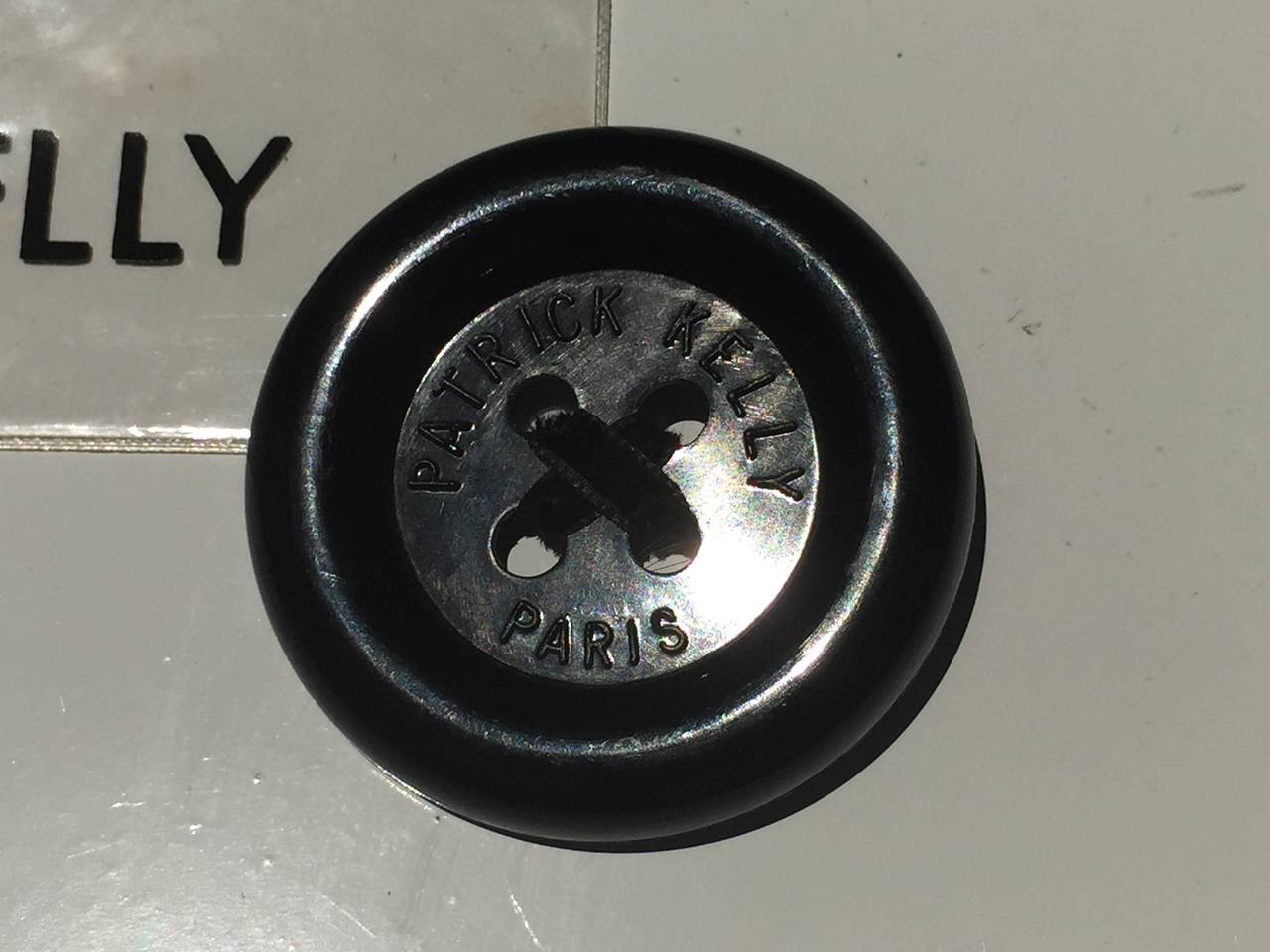 Patrick Kelly Paris black button pin / brooch. at 1stDibs