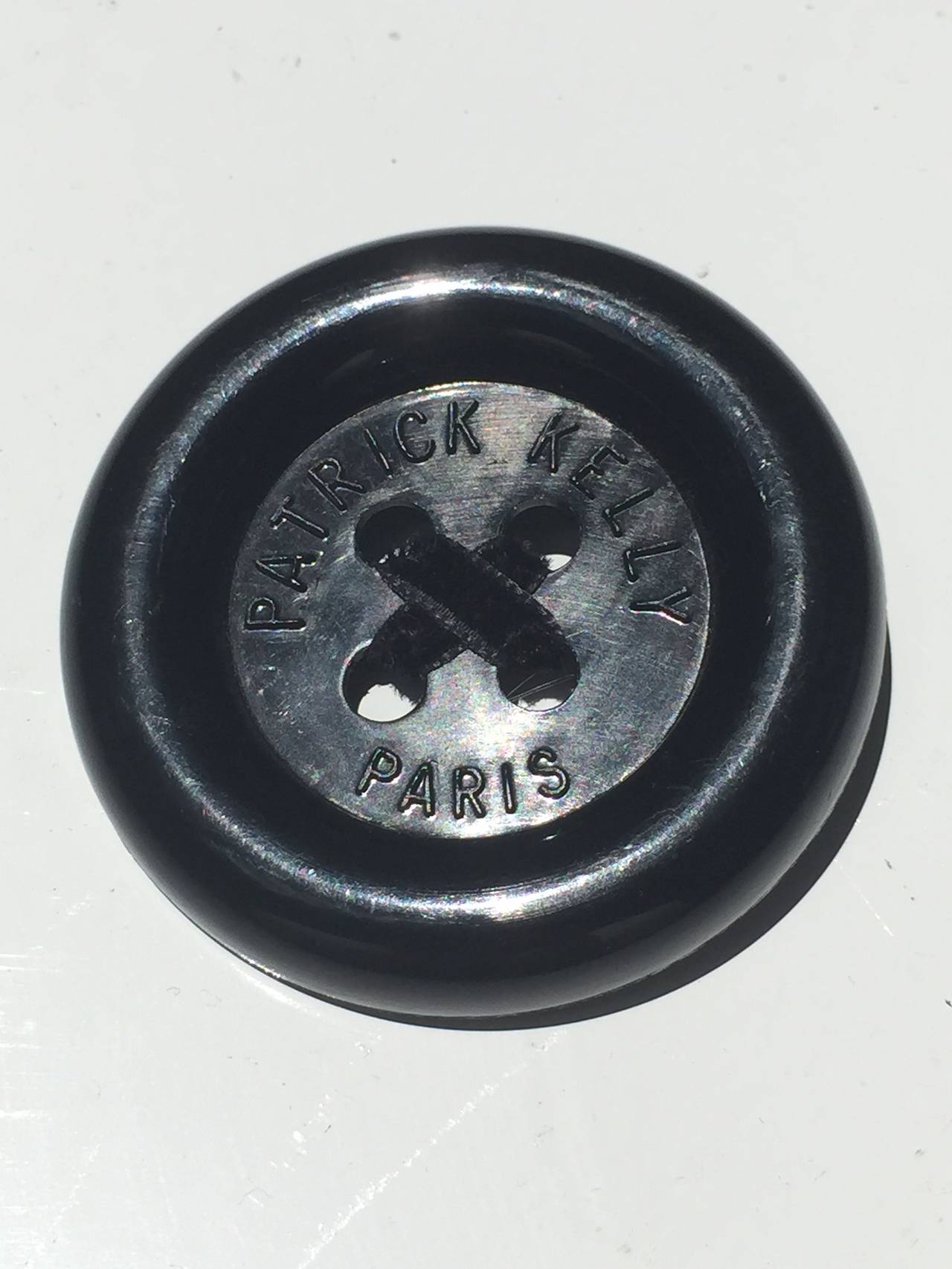 Patrick Kelly Paris black button pin / brooch. at 1stDibs