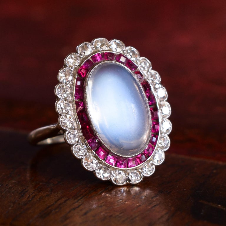 Art Deco Moonstone Ruby Diamond Halo Cocktail Ring at 1stDibs