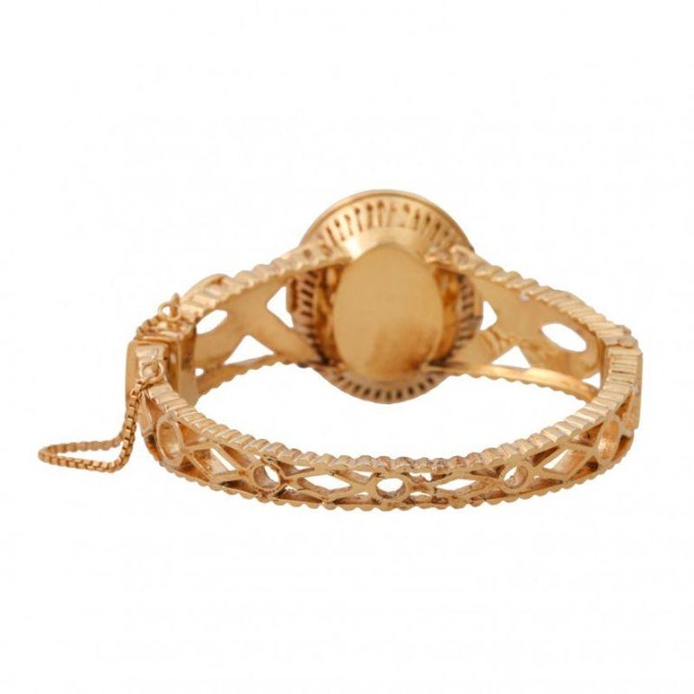 Bangle with Emerald-Encrusted Opening Capsule Top For Sale at 1stDibs