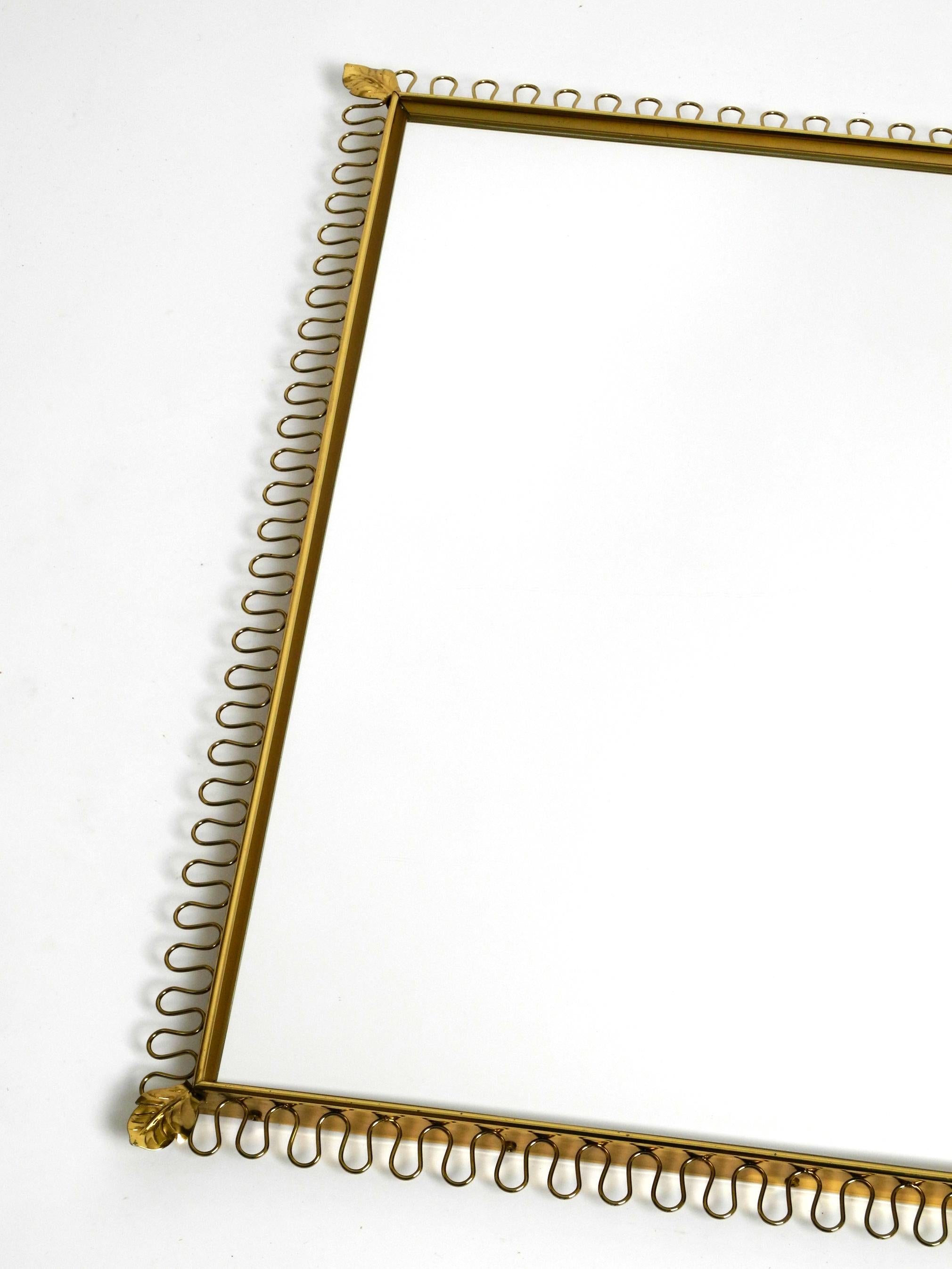 Beautiful original 1960s metal wall mirror in a loop design in gold ...