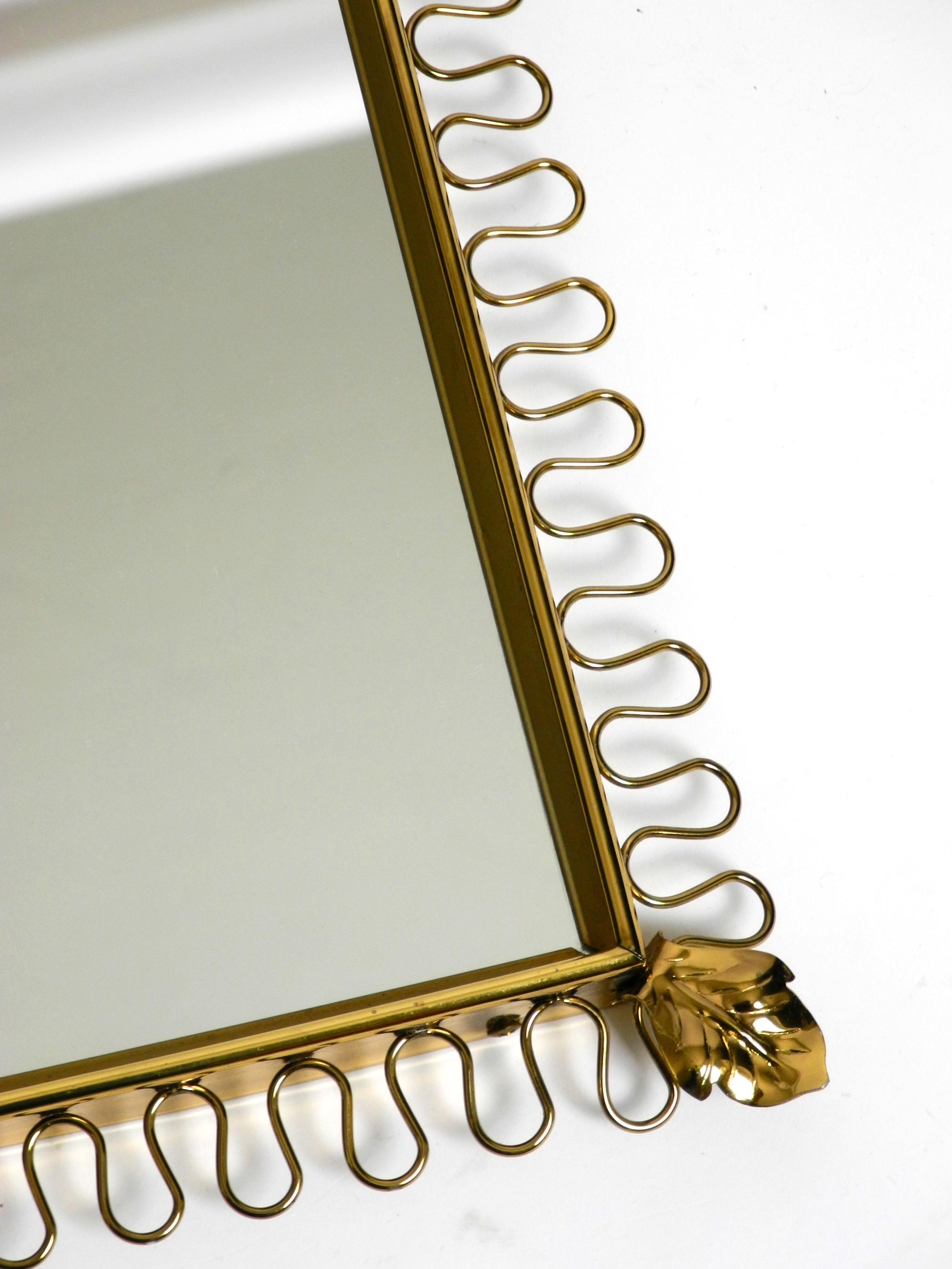 Beautiful original 1960s metal wall mirror in a loop design in gold ...