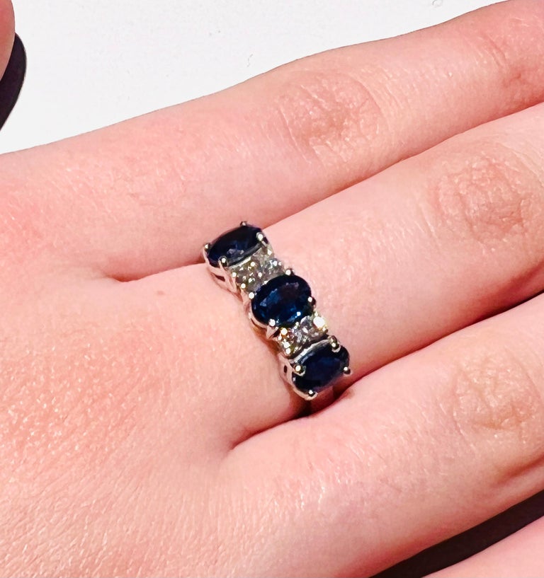 Berca 1.71 Kt Oval Cut Blue Sapphire 0.20 Kt White Diamond Three Stone Ring For Sale at 1stDibs