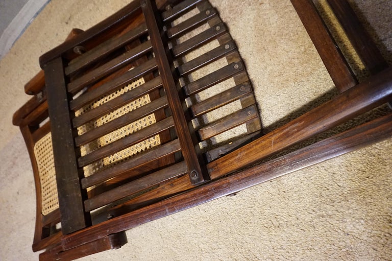 British Colonial Folding Campaign Chair with Cane Work and Bolts at 1stDibs