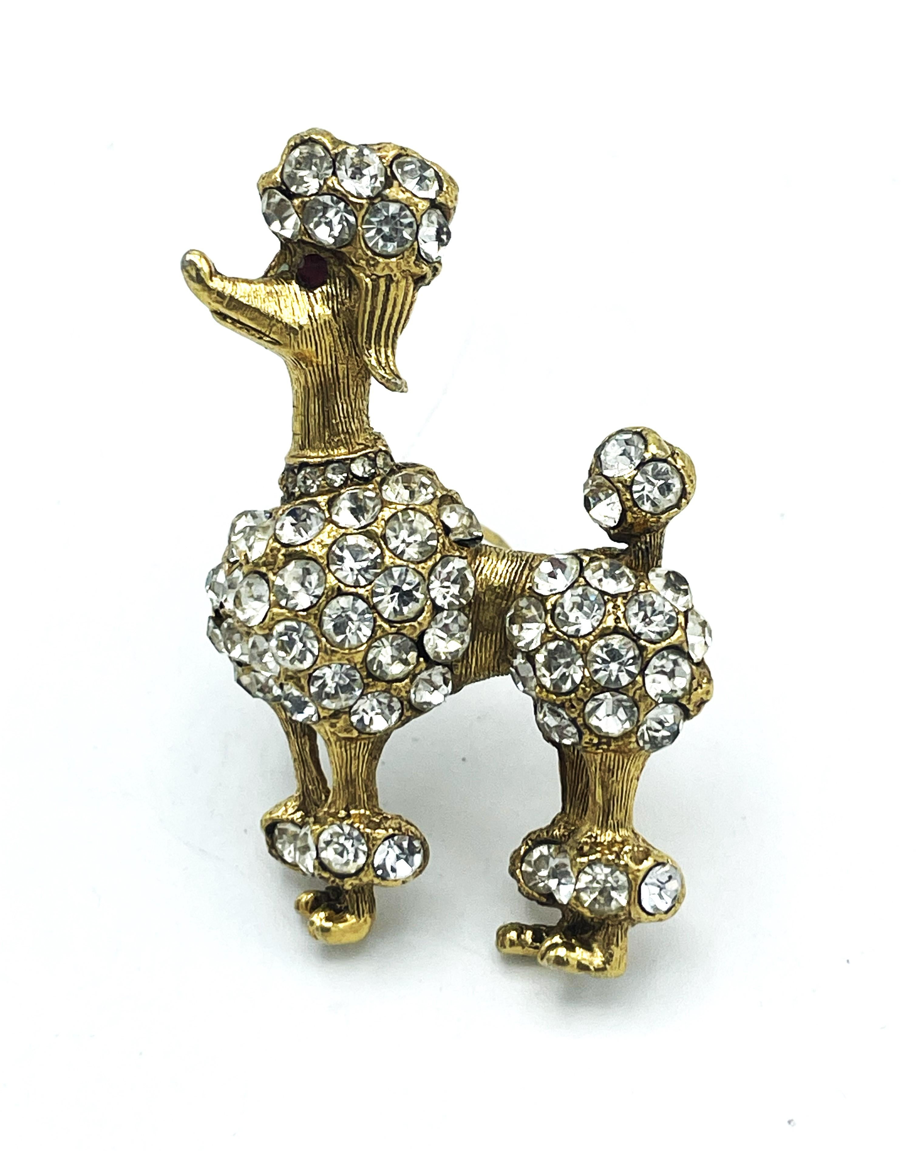 Brooch in the shape of a proud poodle, set with rhinestones, signed BSK ...