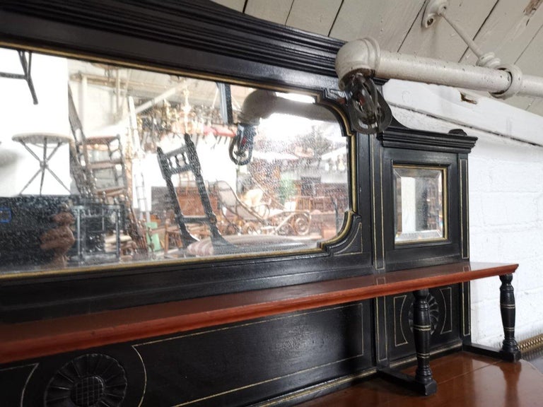Bruce Talbert, attr An Ebonised Side Cabinet Carved with Putti playing ...