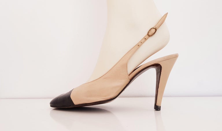 Chanel Beige Leather Heels with Black tip and small belt behind. For ...