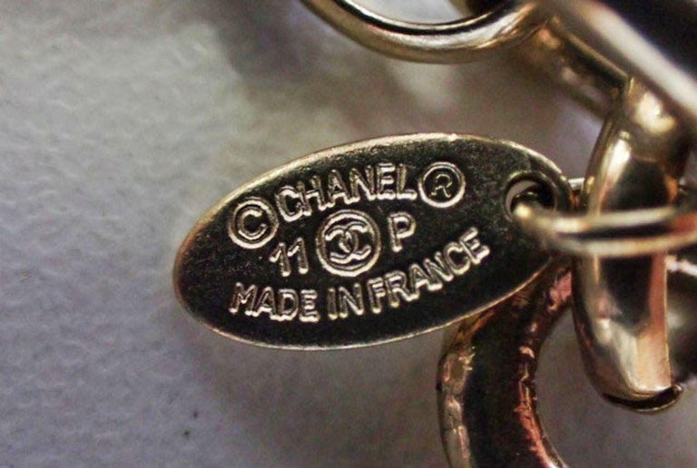 Chanel CC key chain is crafted in light gold-tone hardware and features ...