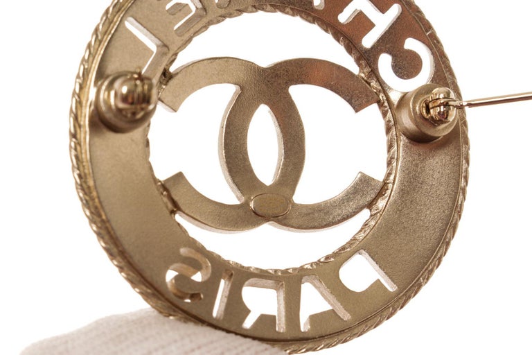 Chanel Silver-Tone Metal CC Paris Round Brooch For Sale at 1stDibs