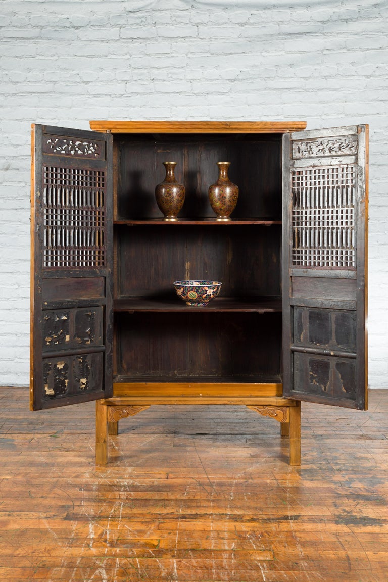 Chinese Early 20th Century Tall Cabinet with Fretwork Motifs and Carved ...