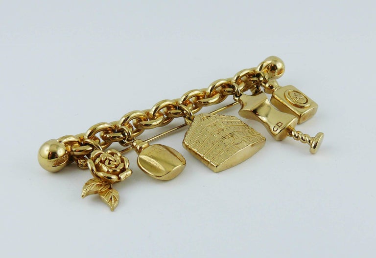 Christian Dior Gold Toned Brooch with Charms at 1stDibs