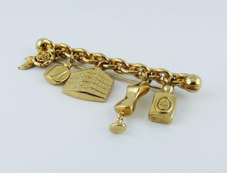 Christian Dior Gold Toned Brooch with Charms at 1stDibs