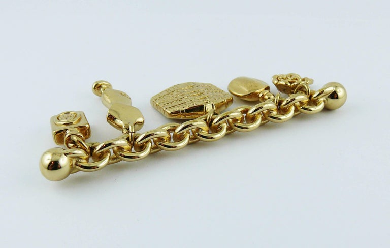Christian Dior Gold Toned Brooch with Charms at 1stDibs