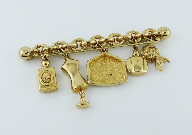 Christian Dior Gold Toned Brooch with Charms at 1stDibs