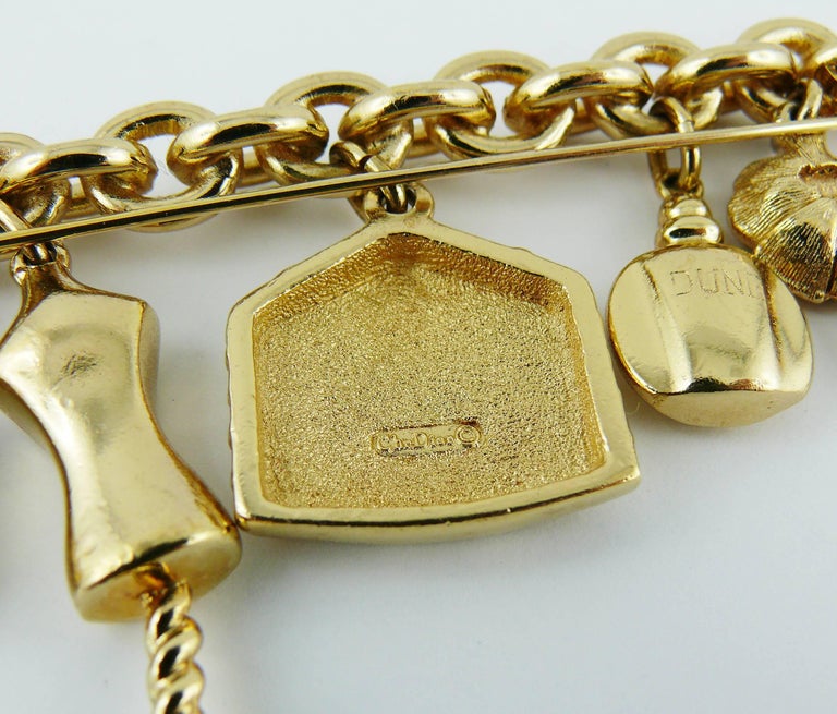 Christian Dior Gold Toned Brooch with Charms at 1stDibs