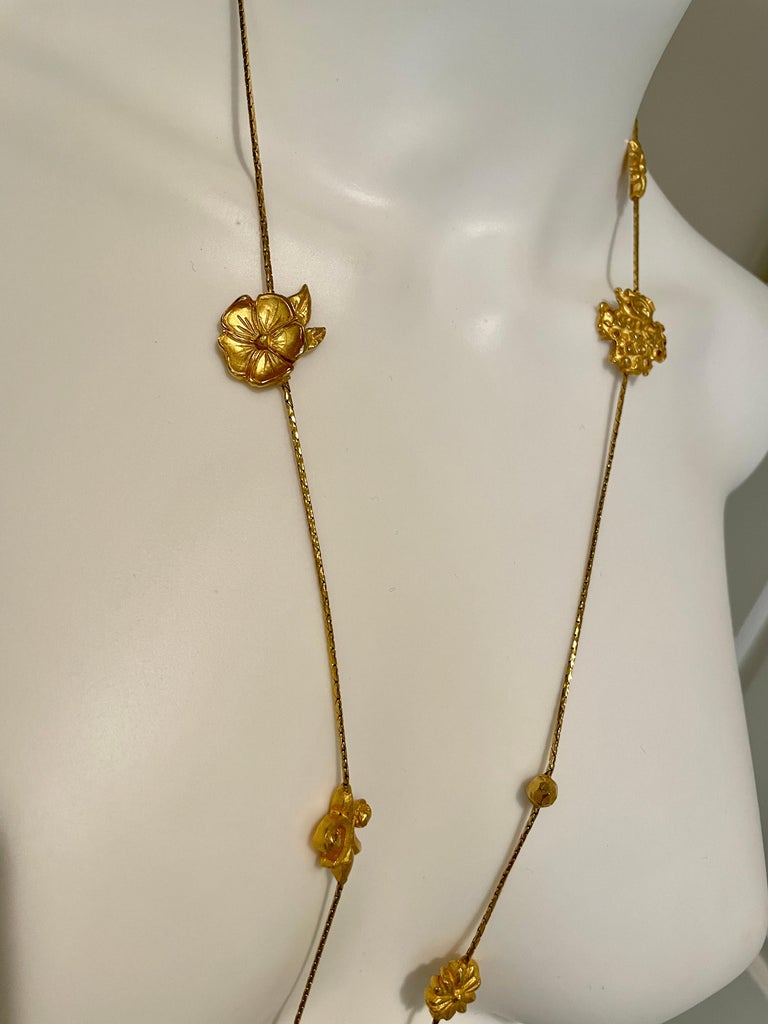 CHRISTIAN LACROIX vintage gold extra long charm necklace at 1stDibs