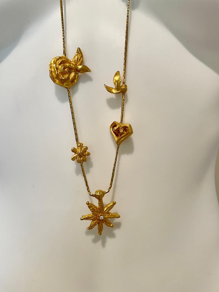 CHRISTIAN LACROIX vintage gold extra long charm necklace at 1stDibs