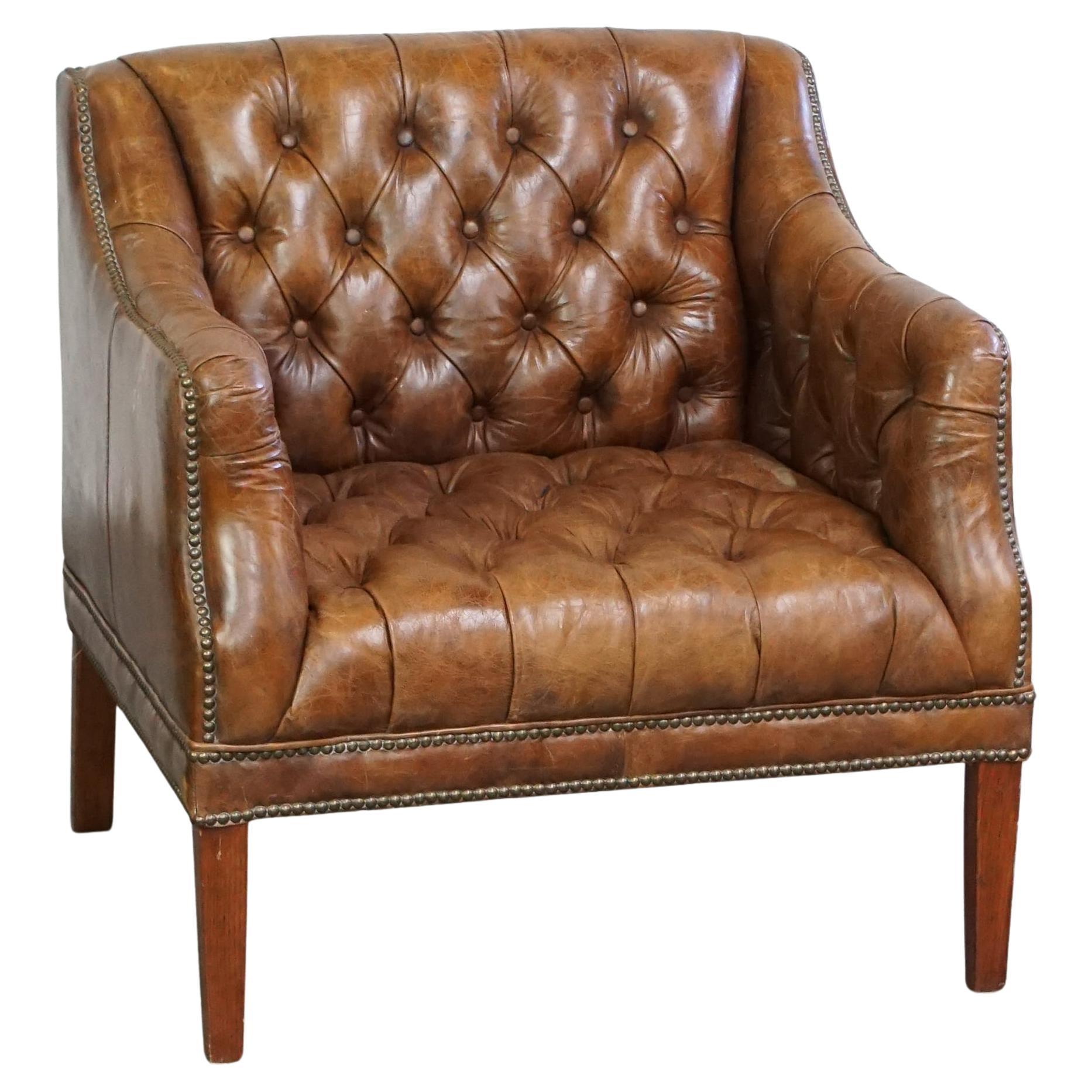 Comfortable leather chesterfield design armchair in a warm cognac brown ...